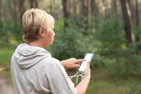 Middle Aged Woman In The Forest Takes Daily Steps Looks At The Route