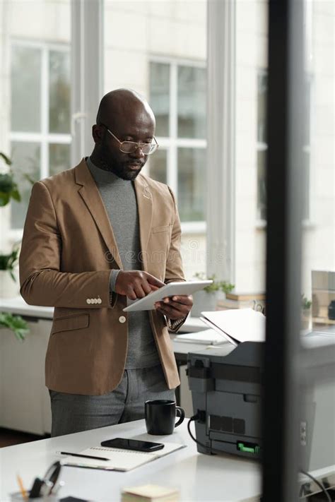 Young Confident Businessman In Formalwear Pointing At Tablet Screen