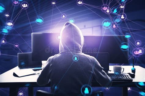 Back View Of Hacker In Hoodie Using Computers At Desk With Connected