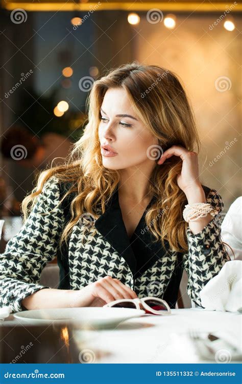 Fashion Portrait Of Pretty Young Blonde Woman Sits In An Expensive