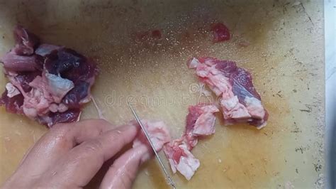 A Woman Is Cutting Beef On A Plastic Board To Prepare Food Stock
