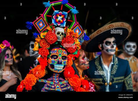 A Mexican Woman Dressed As La Catrina And Wearing Huichol Beaded Mask