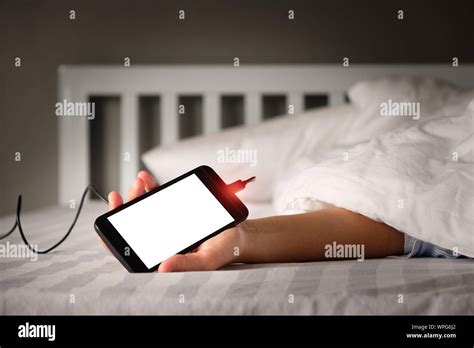 Women Are Using A Mobile Phone While Charging The Battery Red Light Requires A Battery Charger