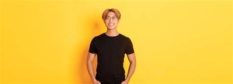 Free Photo Handsome Asian Blond Guy In Glasses Standing In Black