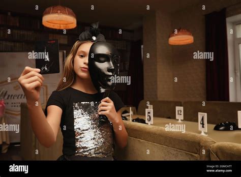 A Girl In A Black Dress Girl With A Mask For A Board Game The Game Is