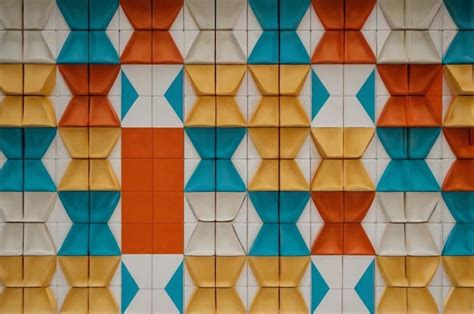 A Colorful Wall With A Pattern Of Different Colored Tiles Premium Ai