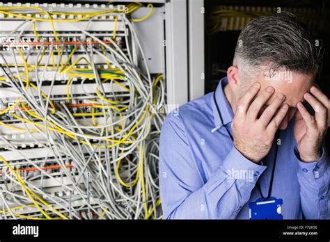 Stressed Technician Working On Broken Server Stock Photo Alamy