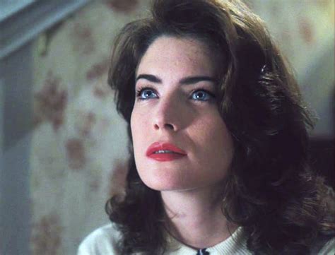 A Close Up Of A Person Wearing A Tie And Looking Off To The Side With A Serious Look On Her Face