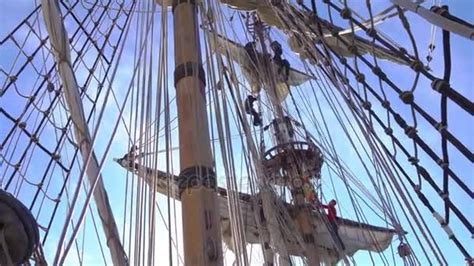 Sailors Climb Up The Mast On A Rope Ladder On A Traditional Sailing