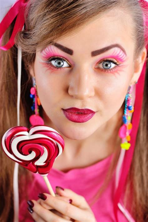 Beautiful Girl With Creative Makeup With Heart Shaped Lollipop Stock