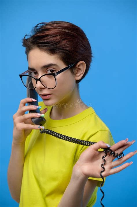 Beautiful Young Skinny Brunette Talking Quietly On A Landline Phone