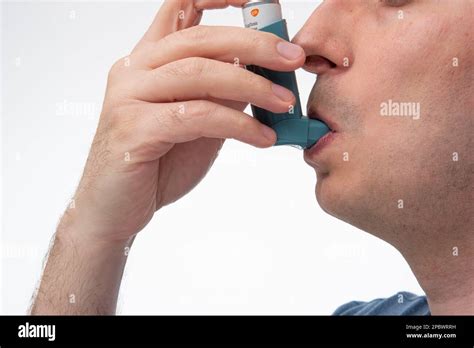 Asthma Inhaler Generic Non Branded Being Used By Unrecognizable By Man Close Up Studio Shot