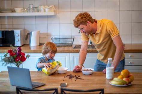 Ginger Man And His Son Spending Time Together And Looking Involved