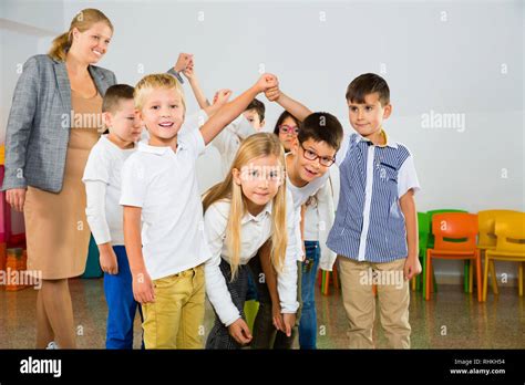 Positive Happy Cheerful Smiling Female Teacher Playing Circle Game With