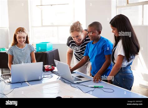 Group Of Students In After School Computer Coding Class Learning To