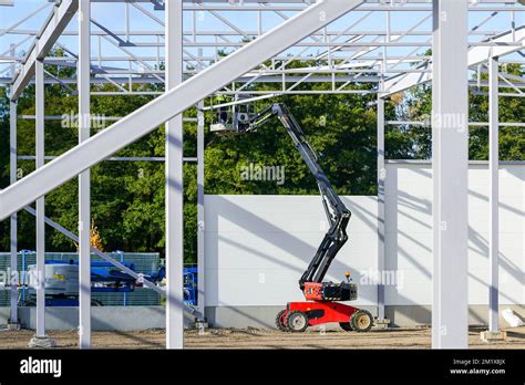 New Building Steel Framework Assembly Using Self Propelled Lift Platform Unfinished Warehouse