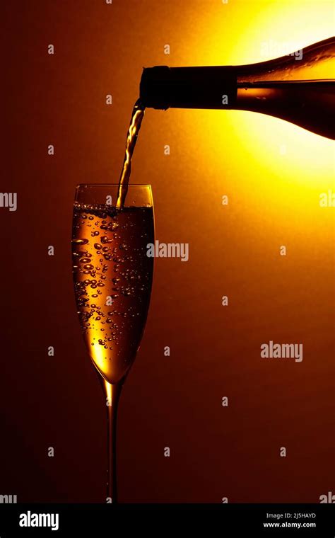 Sparkling Wine Is Poured From A Bottle Into A Glass Copy Space Stock