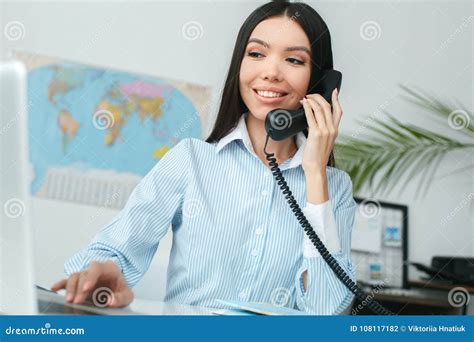 Young Female Travel Agent Consultant In Tour Agency Answer Phone Call