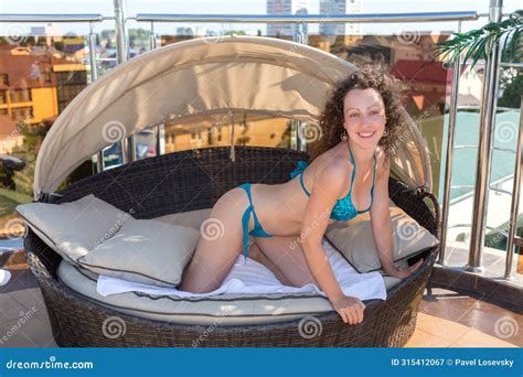 Woman In A Swimsuit On A Wicker Couch On The Stock Image Image Of