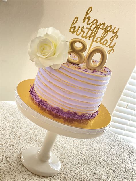 80th Birthday Cake With Purple Icing And White Flowers