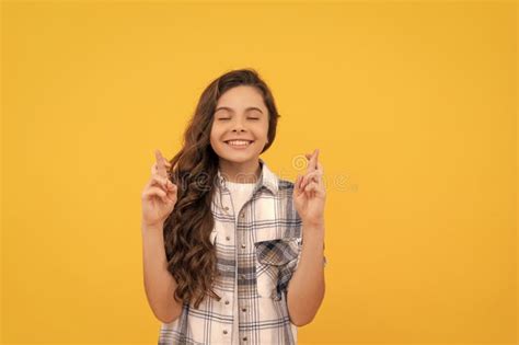 Dreamy Teen Girl In Checkered Shirt Make A Wish On Yellow Background