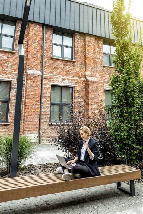 Young Business Woman Sitting In A Lotus Pose And Working On Laptop