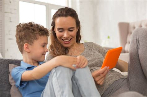 Laughing Mother Smiling Broadly While Telling Jokes Stock Photo Image Of Generation