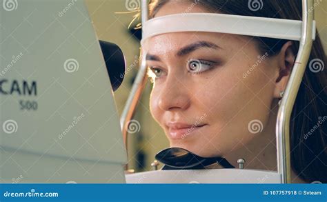 A Woman Positions Her Head Firmly Before An Eye Test Stock Footage Video Of Sight