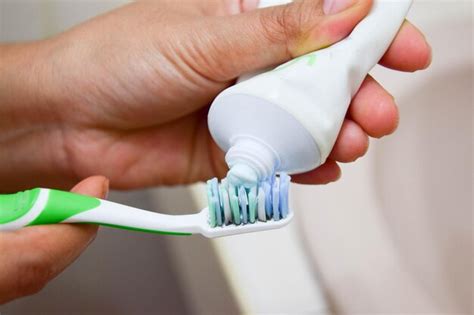 Premium Photo Cropped Hands Of Person Removing Toothpaste On Brush