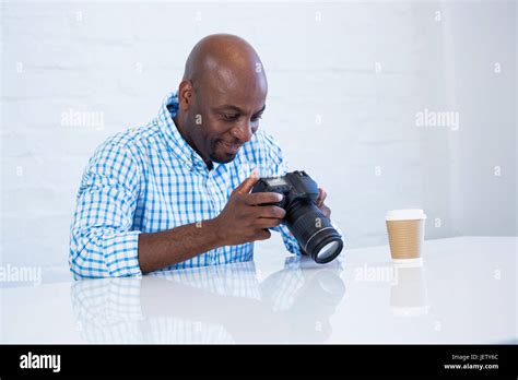 Man Checking Photo In Camera Stock Photo Alamy