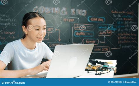 Cute Asian Girl Programing System By Using Laptop At Blackboard