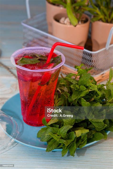 여름 민트 딸기 상쾌한 칵테일 모히토는 플라스틱 유리 배경에 얼음이 있다 탄산 미네랄 워터 음료용 유리 바 메뉴의 레모네이드 클래식 스파클 음료 모히토에 대한 스톡 사진 및