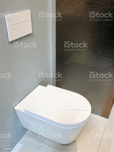 현대 흰색 고급 화장실 욕실 스위트 룸의 이미지 현대 벽 걸려 화장실 팬 Wc 화장실 벽에 매달려 큰 베이지 색 돌 화강암 바닥 타일 타일 바닥 자연 채광반 반투명 서리가