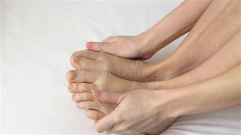 The Girl Is Rubbing Cream On Her Feet With Problem Areas Of The Skin