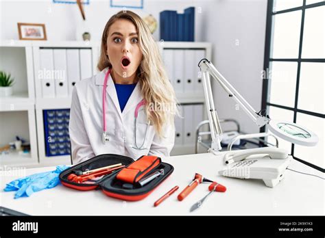 Young Beautiful Doctor Woman With Reflex Hammer And Medical Instruments