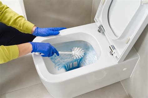Premium Photo Wall Mounted Toilet Cleaning Hotel Maid Cleans Toilet