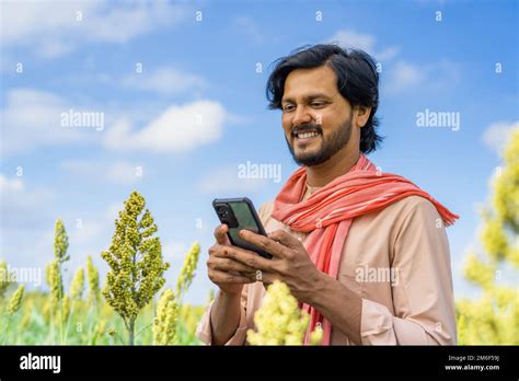 Happy Farmer Using Mobile Phone At Corn Field Concept Of Technology