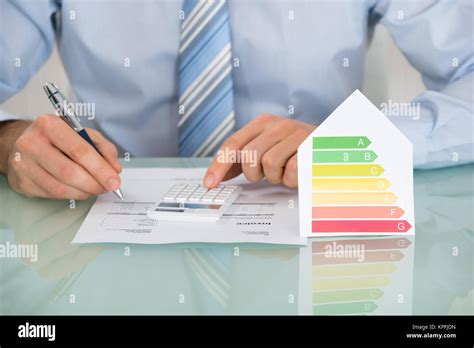 Businessman Calculating Energy Efficiency Rate Stock Photo Alamy