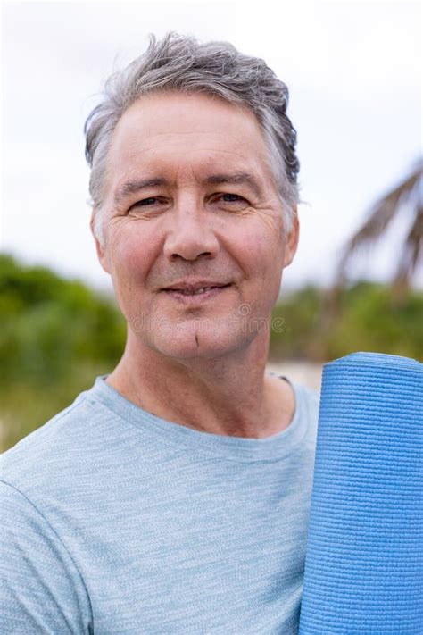 Close Up Portrait Of Smiling Caucasian Senior Man With Blue Exercise