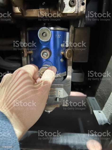 야금 산업에서 Cnc 레이저 절단기를 정확하게 절단하기 위해 렌즈를 조정하고 조정하는 인식 할 수없는 사람의 손의 수직 클로즈업