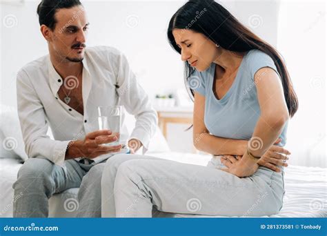 Young Wife With Health Problem At Home Husband Taking Care Of Wife