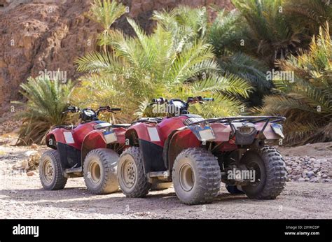 Four Wheeled All Terrain Vehicle Quad In The Desert Against The