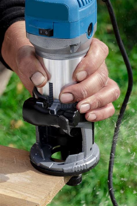 Closeup Of Carpenter With Hand Wood Router Machine At Work Closeup Of Routing A Bevel Into