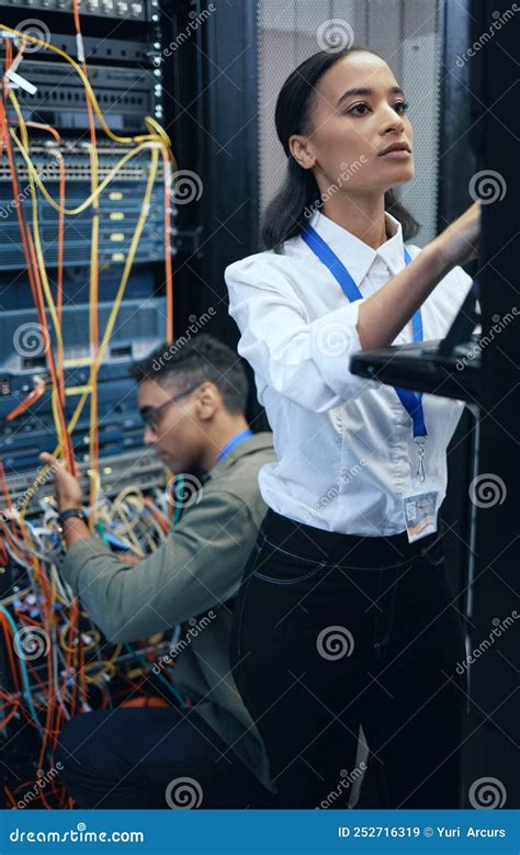 The Coding Team You Need Two Young Computer Programmers Working Together In A Server Room