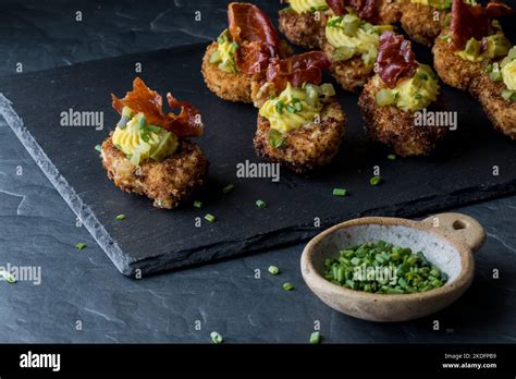 Deep Fried Deviled Egg Appetizers On A Black Slate Board Ready For