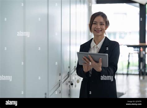 Portrait Asian Business Woman With Stylus Pen Writing On Digital