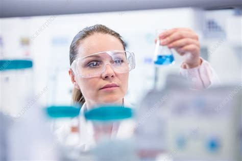 Lab Assistant Holding Chemical Flask Stock Image F020 3285 Science Photo Library