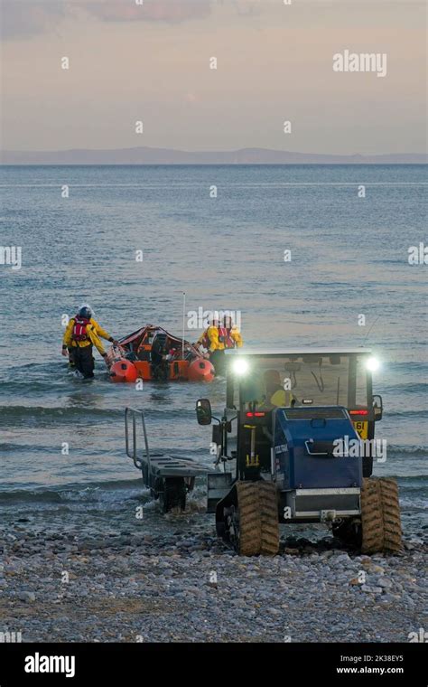 Rnli Inshore Lifeboat Returning To Lifeboat Station Assisted By Beach