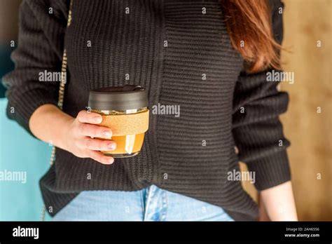 Close Up Of Businesswoman Holding Reusable Takeaway Glass Coffee Cup