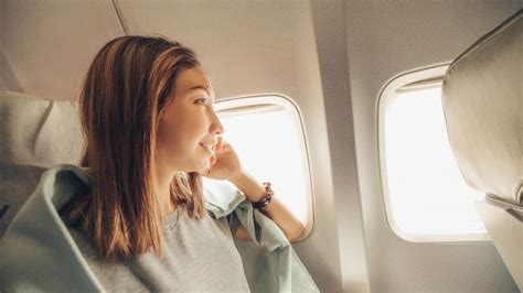 Woman Records Fellow Plane Passenger Leaning Over Her To Take Pictures